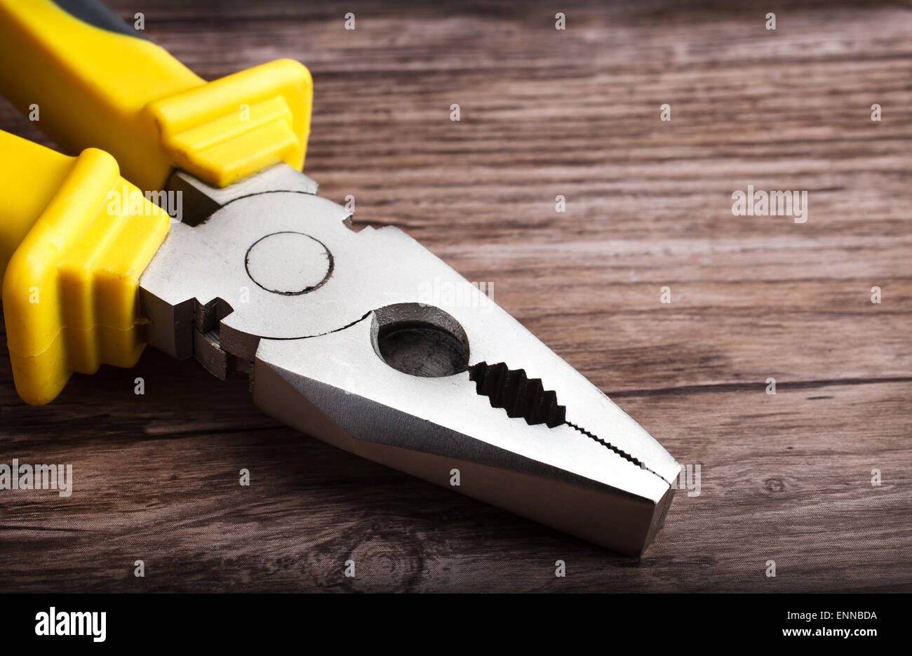 Close up of a multitool pliers on wooden background Stock Photo - Alamy