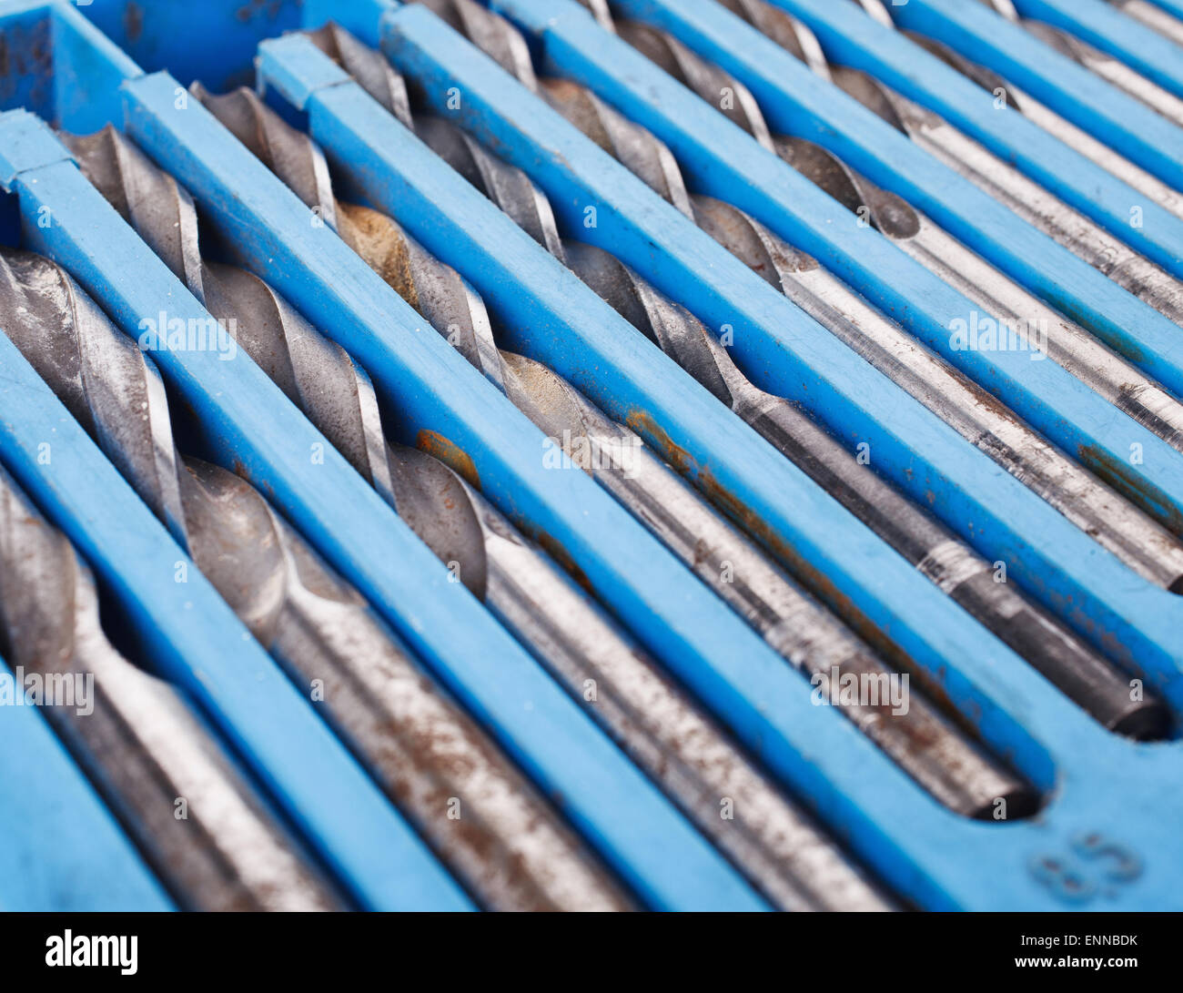 Drill bit set in box background Stock Photo - Alamy