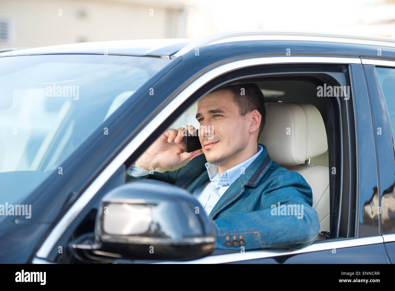 Young man inside car with phone Stock Photo - Alamy