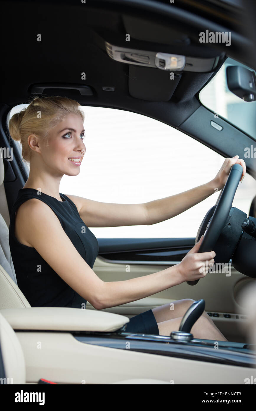 Beautiful young woman driving car Stock Photo - Alamy