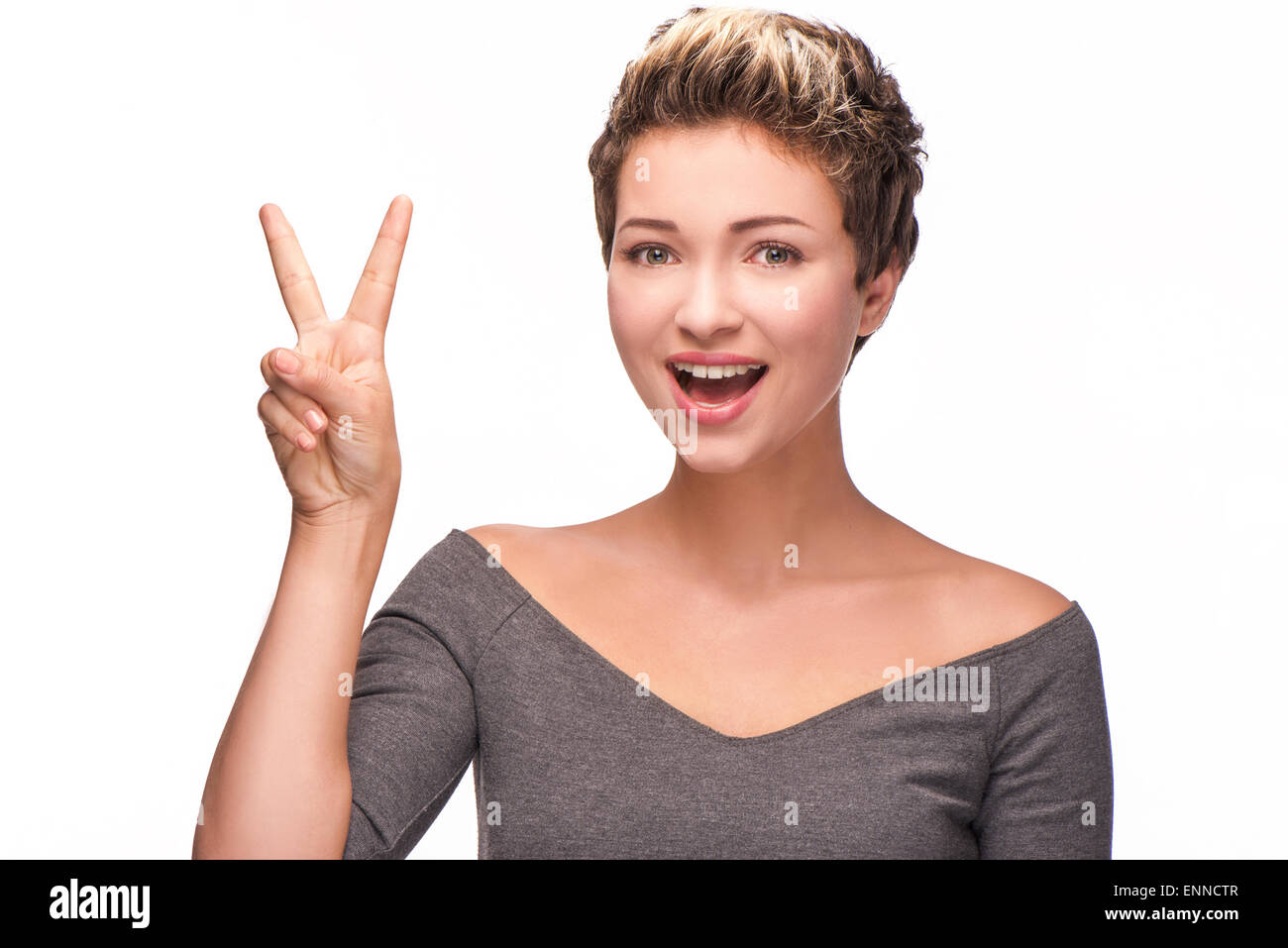 Young woman showing victory sign Stock Photo - Alamy