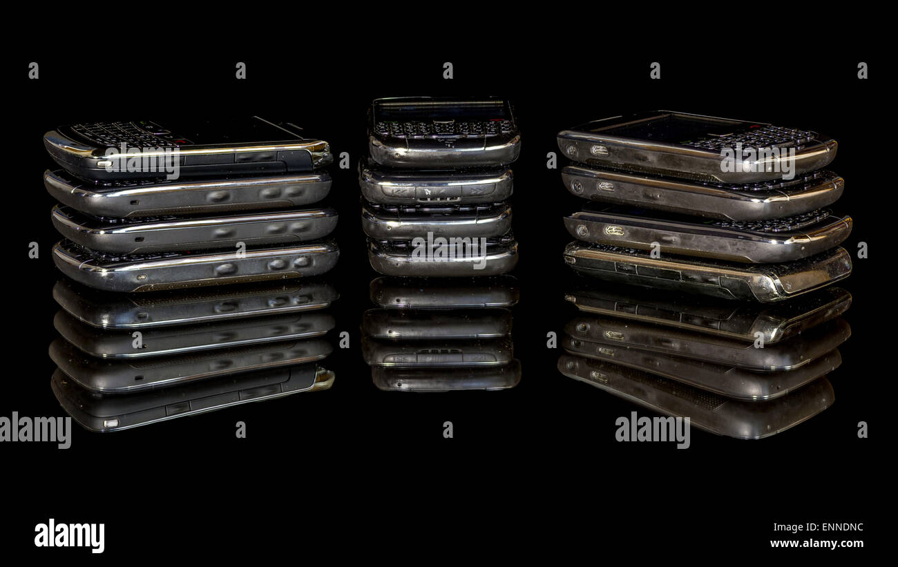 Neatly stacked smart phones on a reflective surface Stock Photo - Alamy