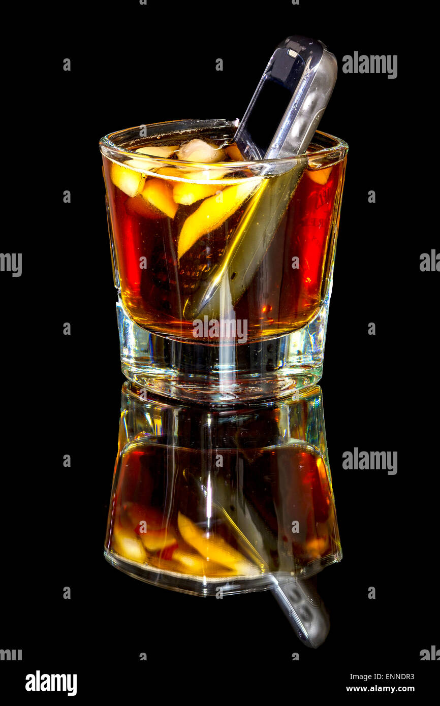 Mobile phone dunked into a glass of whiskey Stock Photo - Alamy