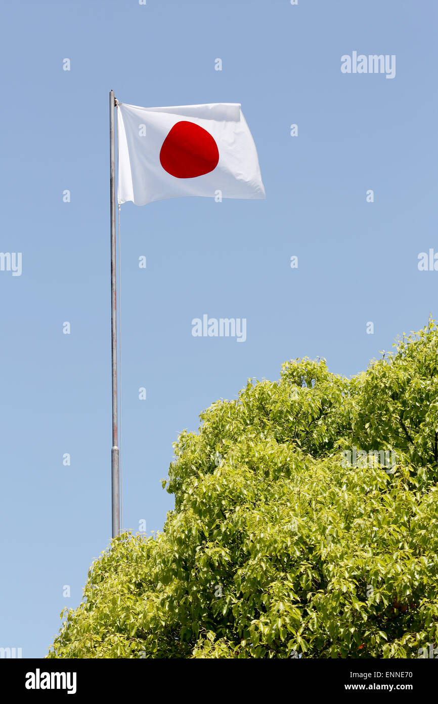 Japanese flag in wind against clear blue sky Stock Photo - Alamy