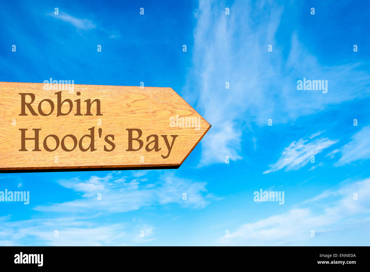 Wooden arrow sign pointing destination ROBIN HOOD BAY, ENGLAND against ...
