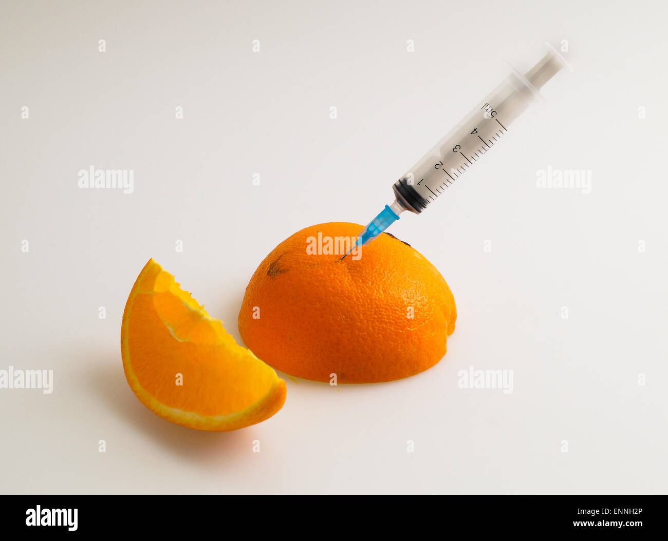 orange with syringe, in slice and on white background Stock Photo - Alamy