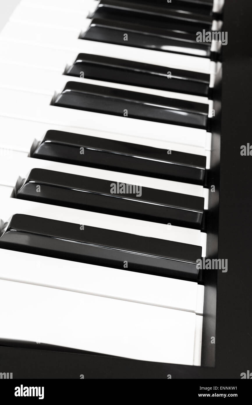 side view of black and white keys of musical digital keyboard close up ...