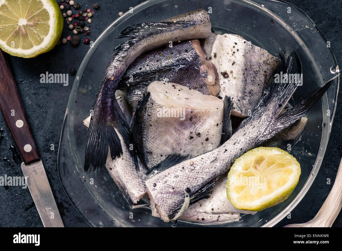 Pieces of fish pollock in glassware with lemon and spices Stock Photo ...