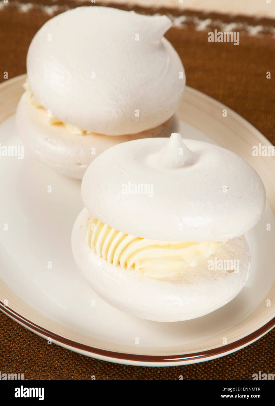 Kiss cakes with cream on a plate, closeup shot Stock Photo - Alamy