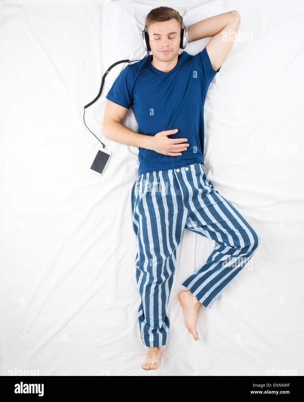 Man listening to music before sleeping Stock Photo - Alamy