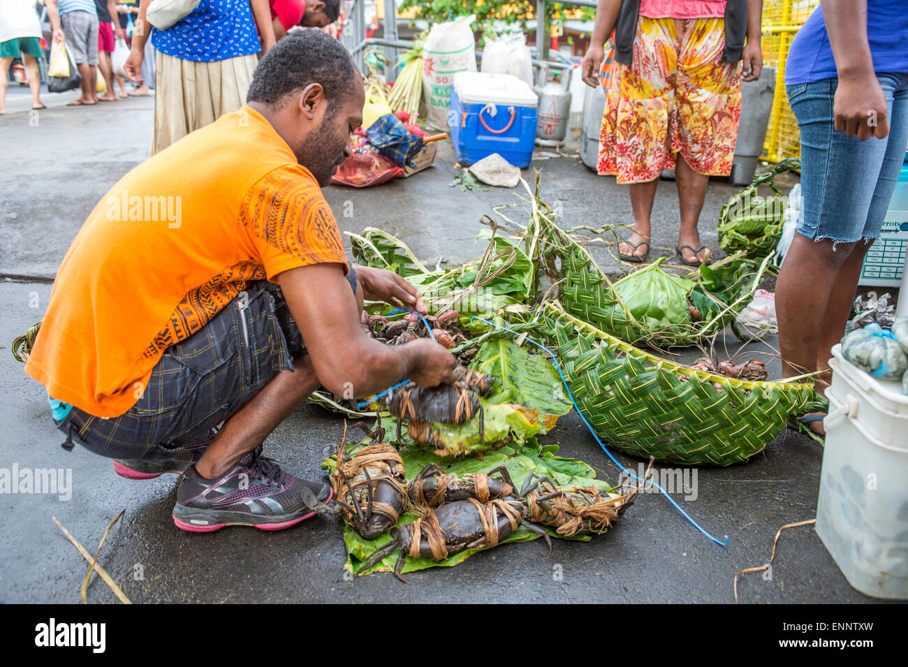 A fisherman with Crabs trussed up for sale. Suva Fish market. Suva ...
