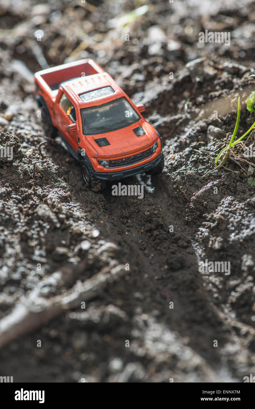 Small red off road car toy in the nature. Miniature Stock Photo - Alamy