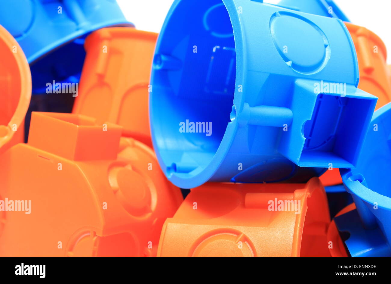 Heap of blue and orange plastic electrical boxes, components for ...