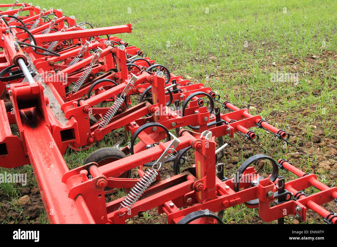 Harrow in green crop field after rainfall Stock Photo - Alamy