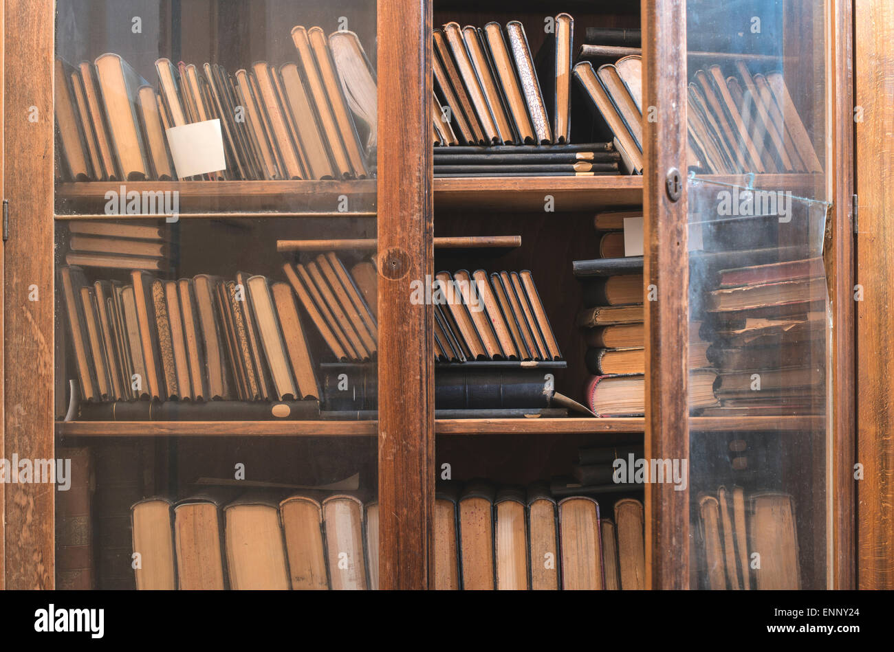Old books in a vintage library shelves Stock Photo - Alamy