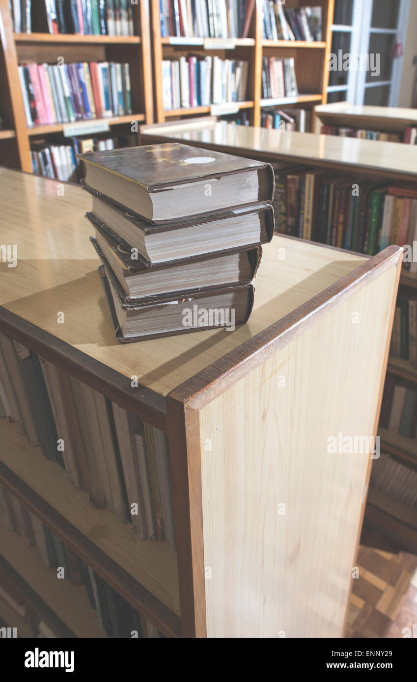 Old books in a vintage library shelves Stock Photo - Alamy