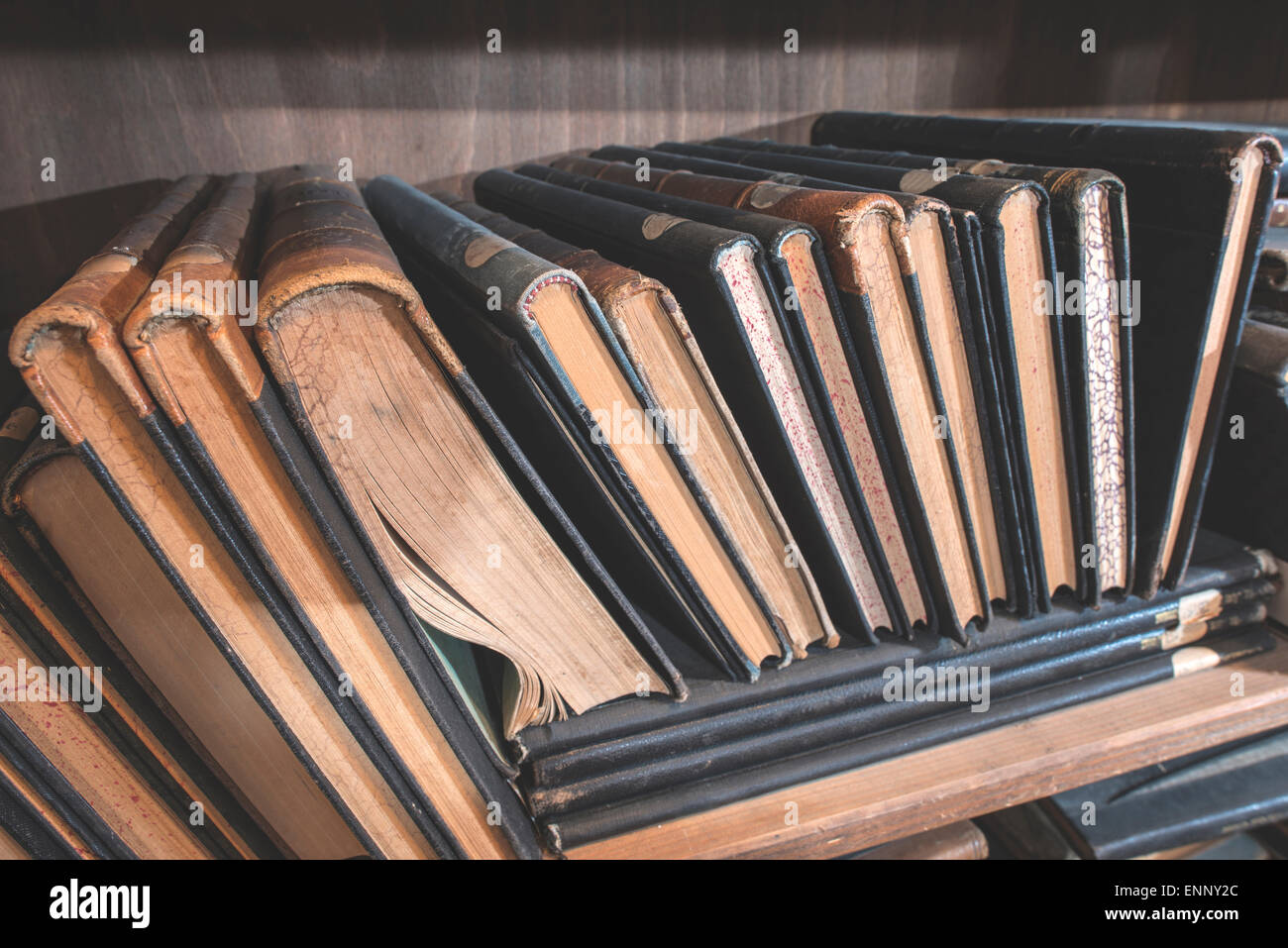 Old books in a vintage library shelves Stock Photo - Alamy