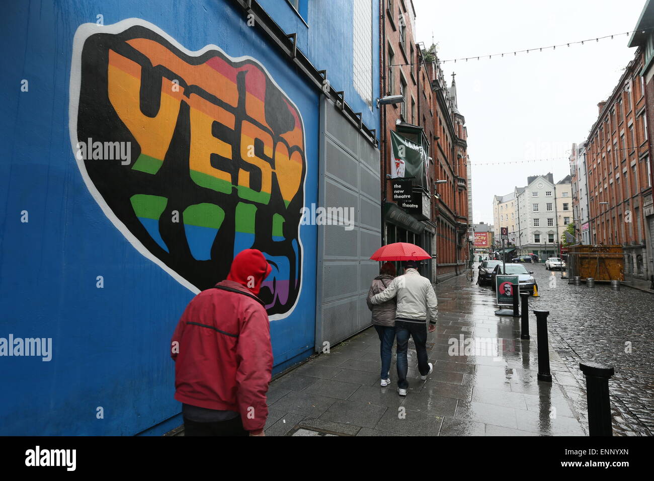 People walk past a 'Yes Equality' marriage referendum mural on a wall ...