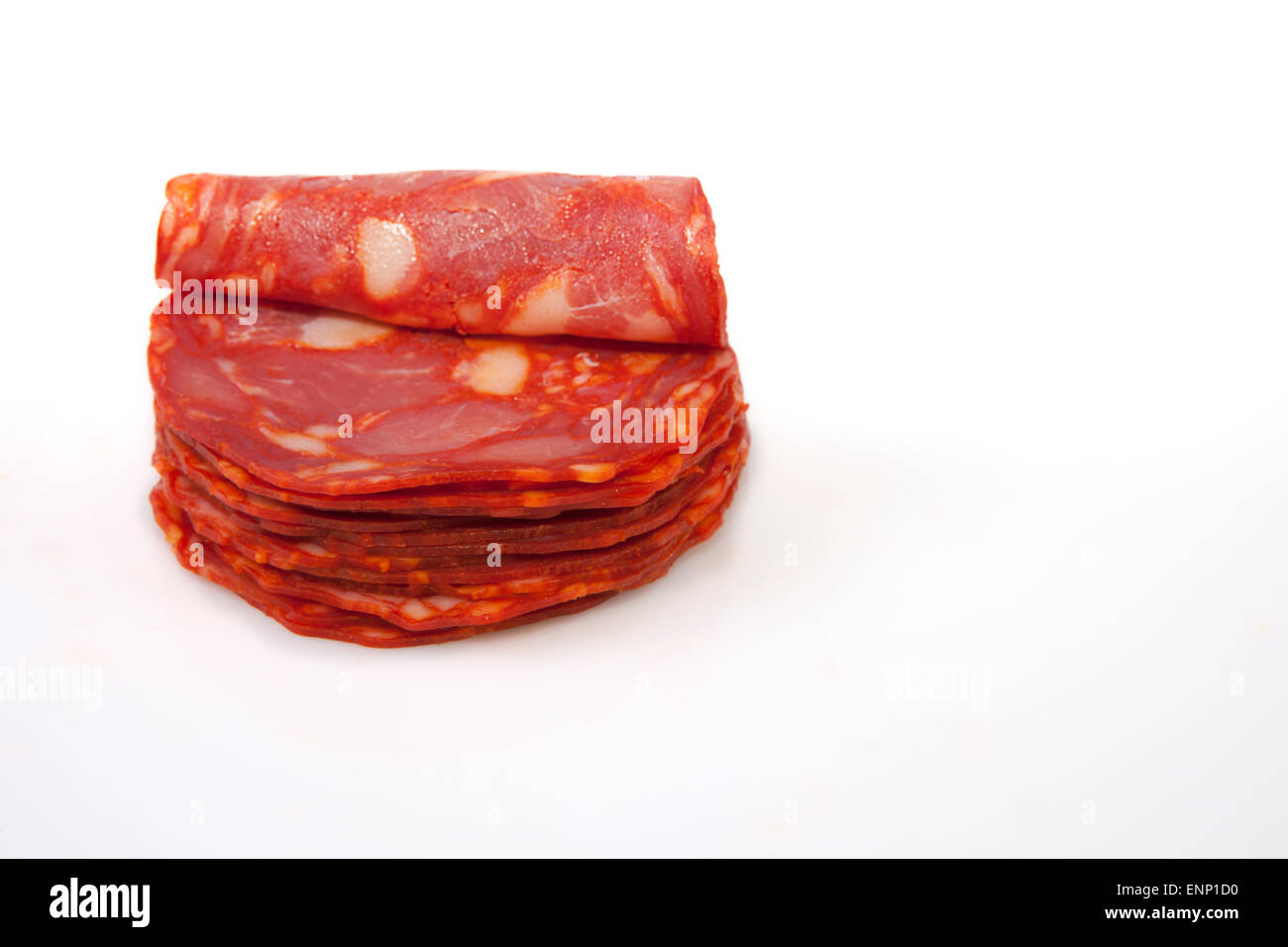 Some cut slices of red iberian chorizo. Isolated over white background ...