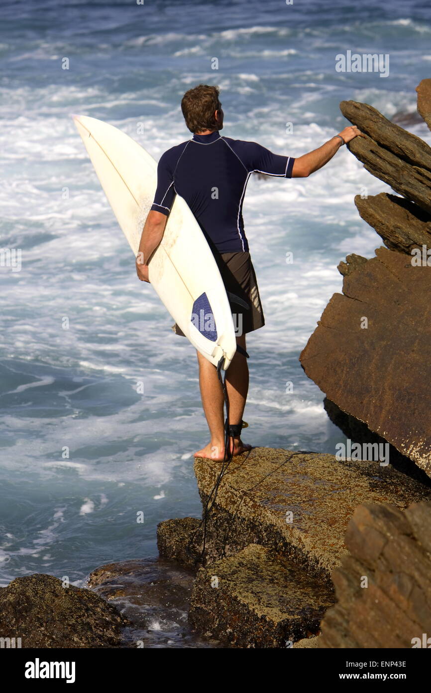 Surfer gazing out to sea looking for the perfect wave Stock Photo - Alamy