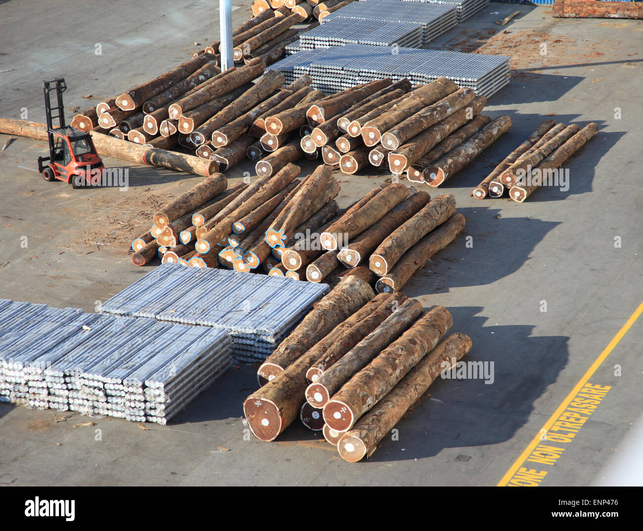Cut timber awaited transport on docks of a port Stock Photo - Alamy