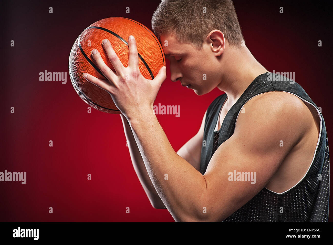 Caucasian male basketball player pressing ball to his forehead Stock ...