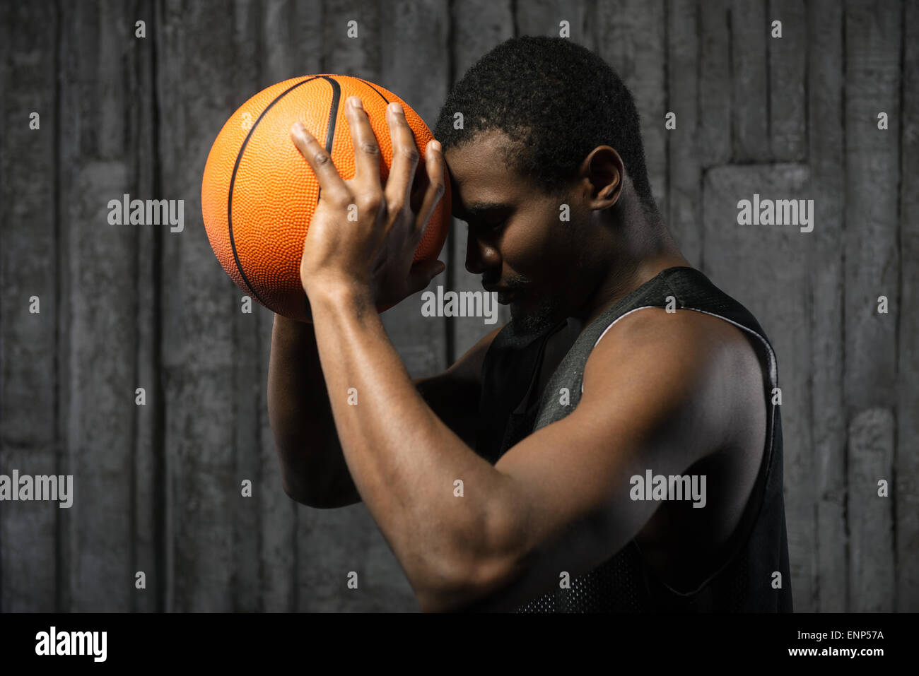 Afro-american basketball player pressing ball to his forehead Stock ...