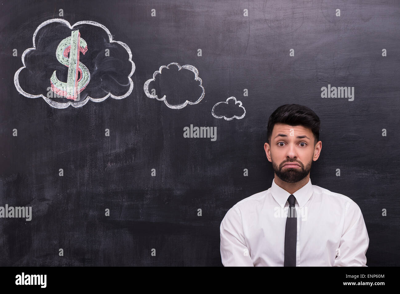 Sad businessman with dollar sign painted on chalkboard Stock Photo - Alamy