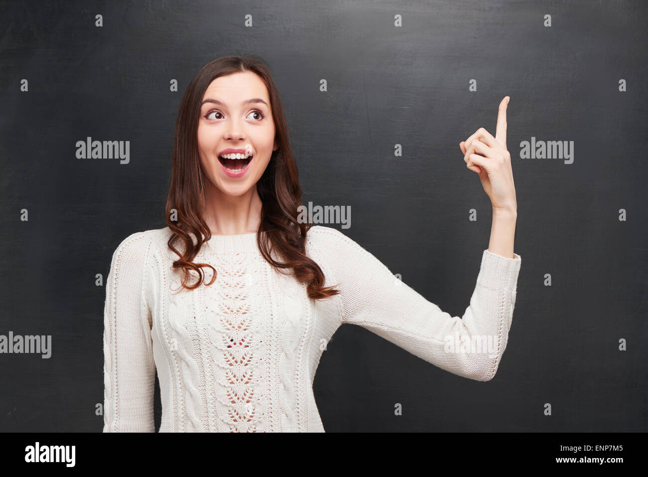 Funny cheerful woman pointing at chalkboard Stock Photo - Alamy