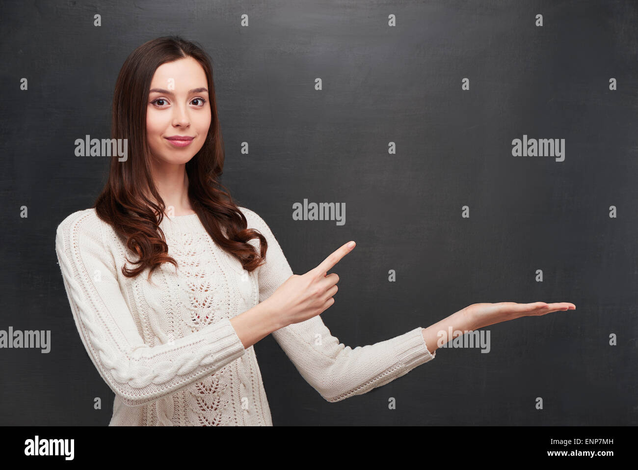 Positive woman pointing at chalkboard Stock Photo - Alamy