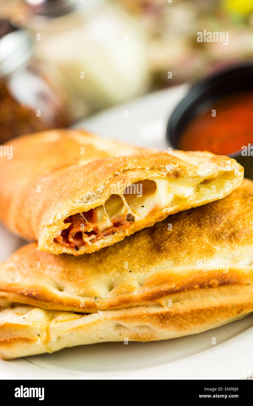 Freshly made Pepperoni calzone in Italian restaurant Stock Photo - Alamy