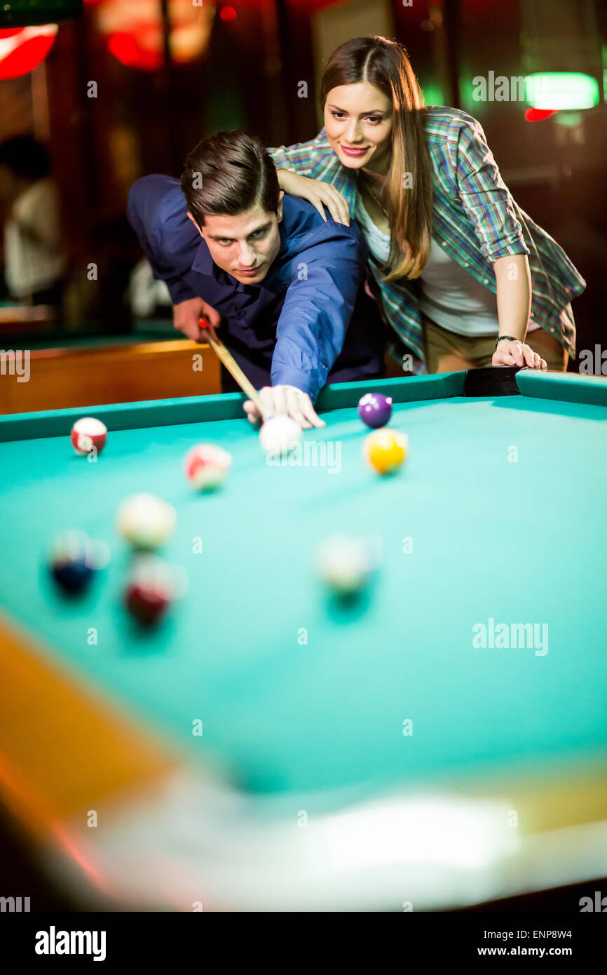 Young couple playing pool Stock Photo - Alamy