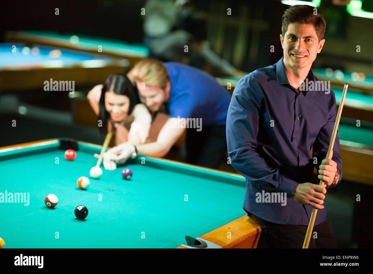 Young people playing pool Stock Photo - Alamy