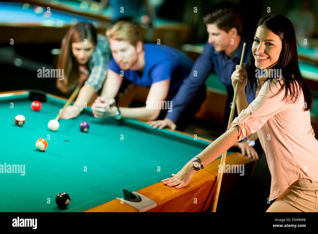 Young people playing pool Stock Photo - Alamy