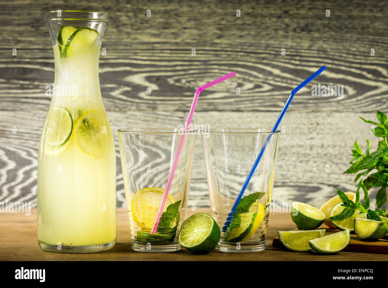 Refreshing lemonade drink and ripe fruits against wooden background ...