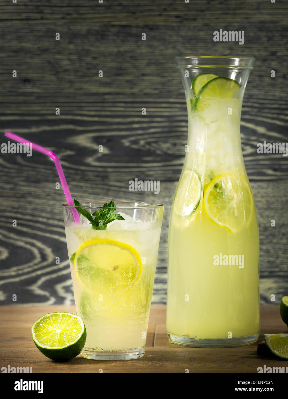 Refreshing lemonade drink and ripe fruits against wooden background ...