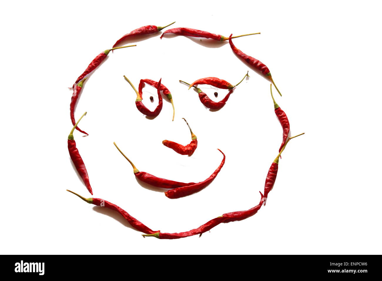 posted smiley face of red chili peppers Stock Photo - Alamy