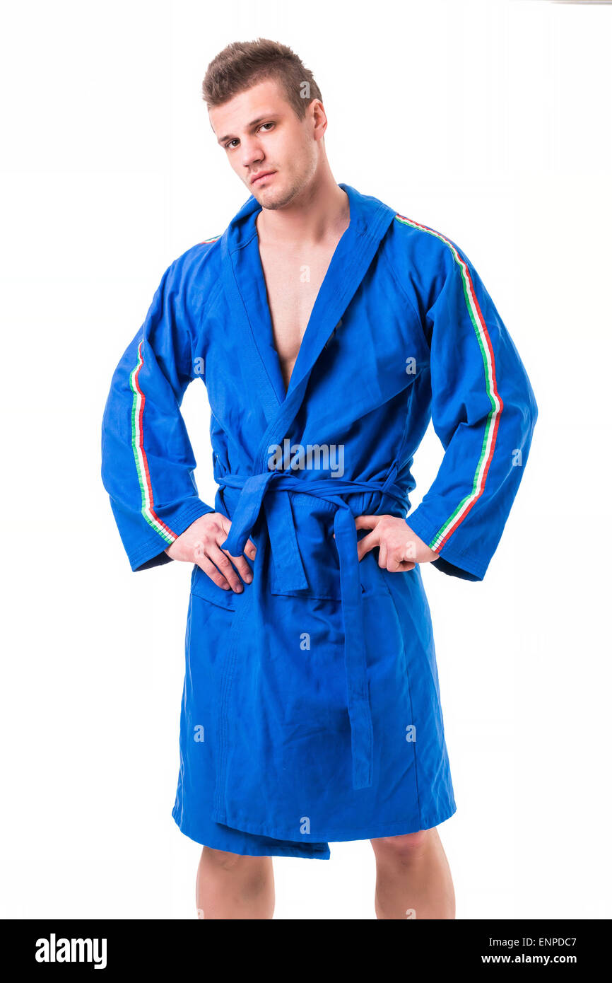 Handsome young man wearing blue bathrobe, isolated on white background ...