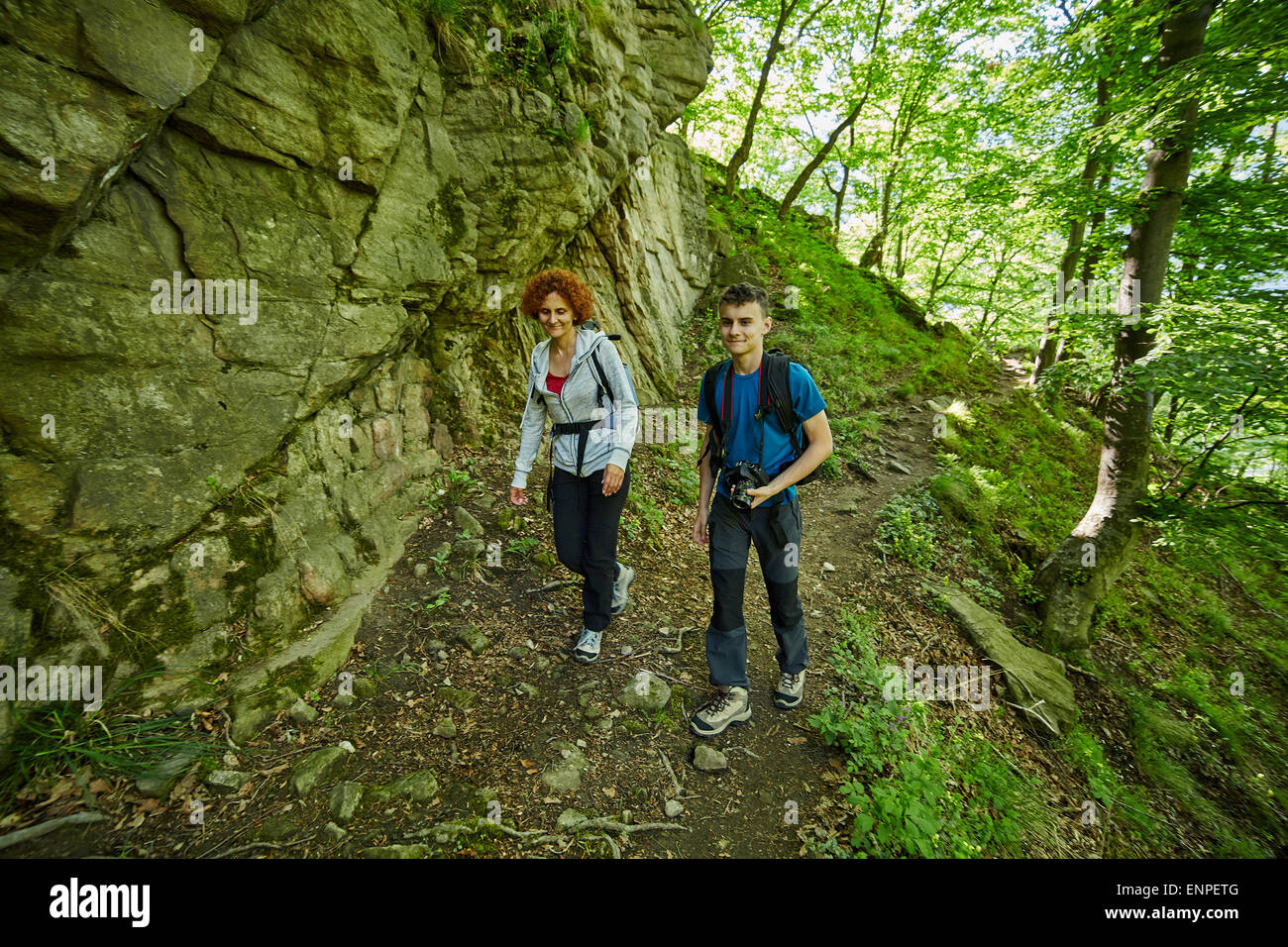 Family of hikers on a mountain trail in a sunny spring day Stock Photo ...