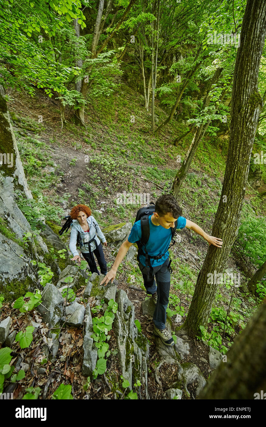 Family of hikers on a mountain trail in a sunny spring day Stock Photo ...