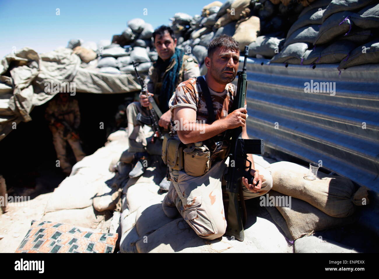 Shingal, Iraq. 7th May, 2015. Peshmerga fighters break and wait for ...