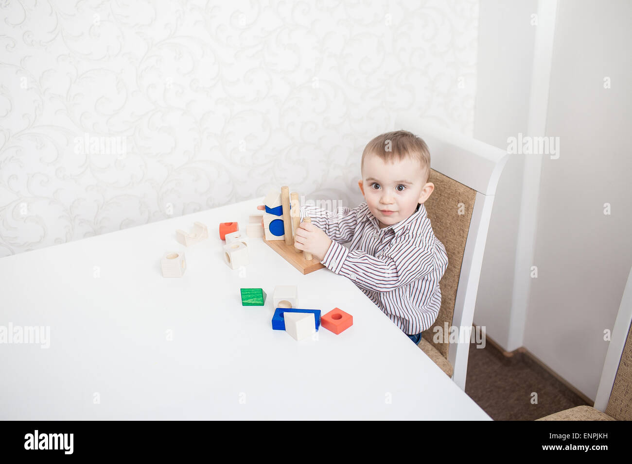 Boy playing with blocks at table hi-res stock photography and images ...