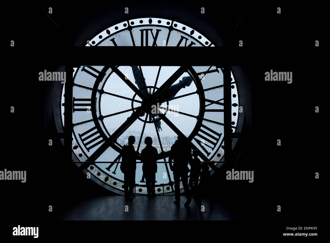 People look through the clock face in Musee d'Orsay at the Seine River ...