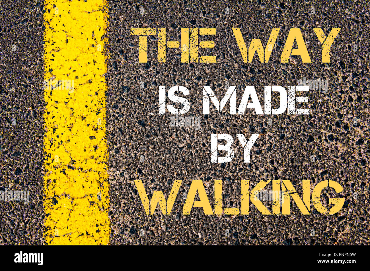 The way is made by walking motivational quote. Yellow paint line on the ...