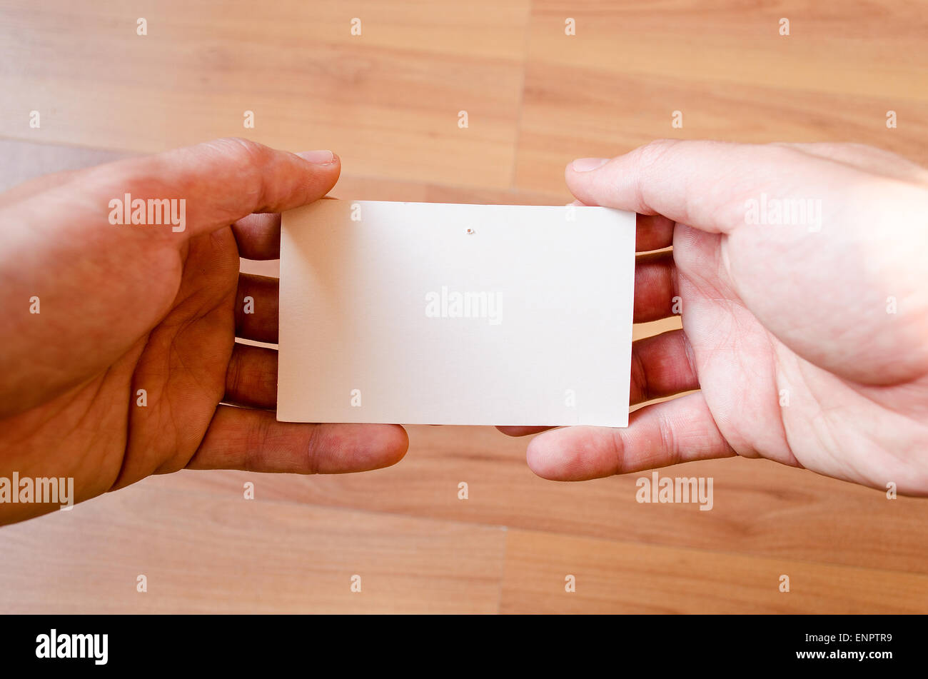 Man hands hold note with wood table office background Stock Photo - Alamy