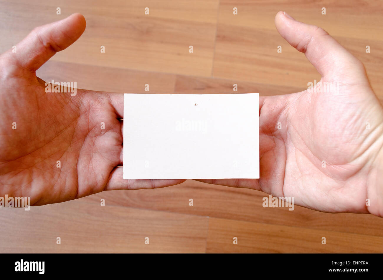 Man hands hold note with wood table office background Stock Photo - Alamy