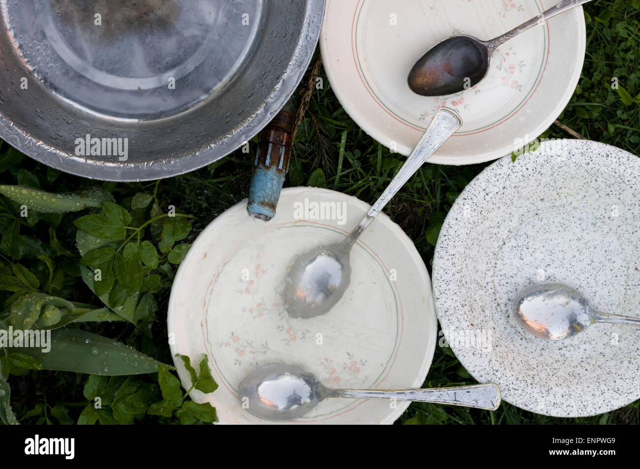Dirty dish ware on the grass Stock Photo - Alamy