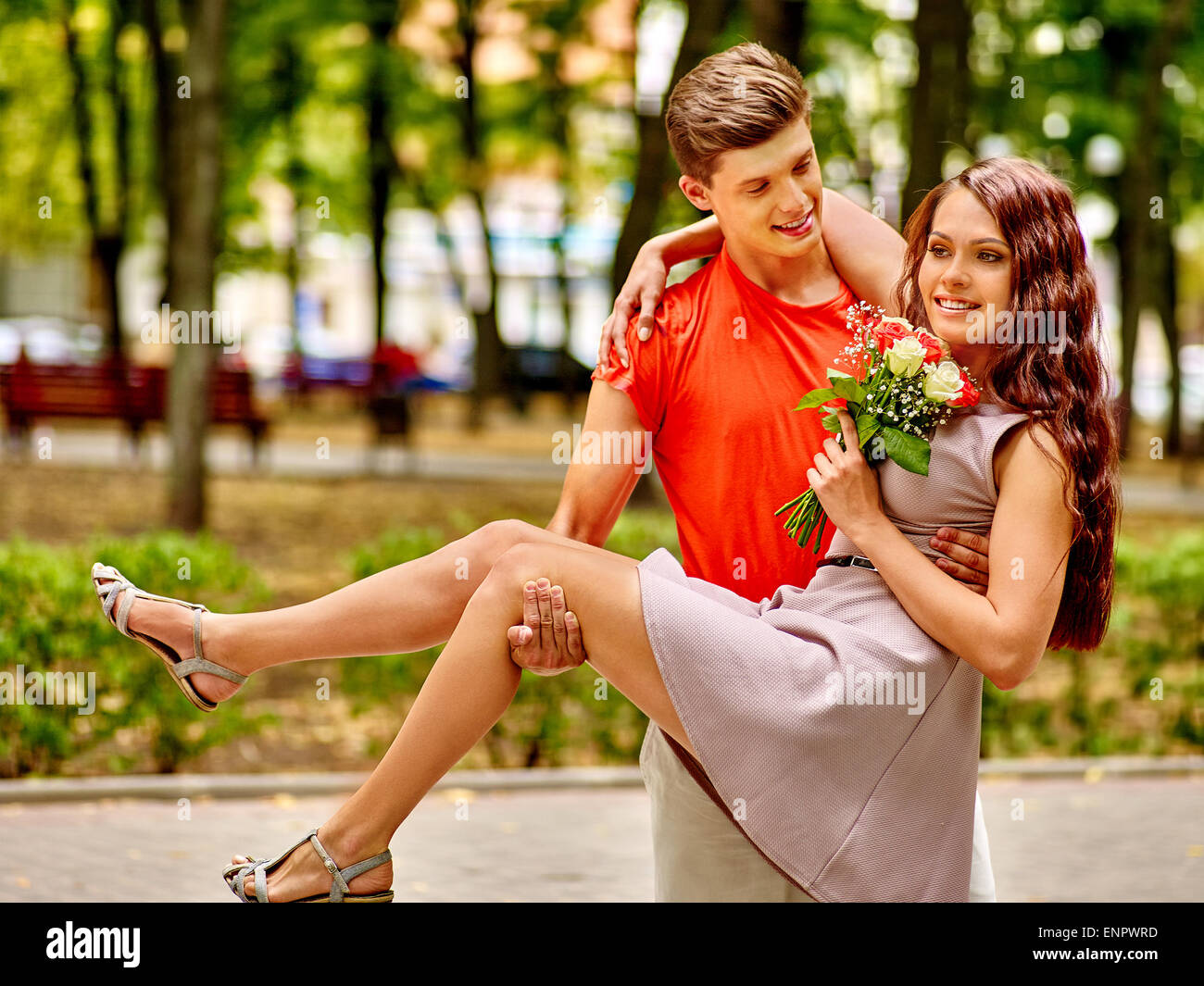 Couple with flower at park Stock Photo - Alamy