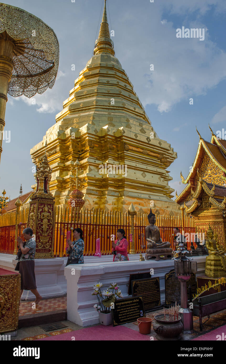 Temple visitors walk around the golden mount as they offer up prayers ...