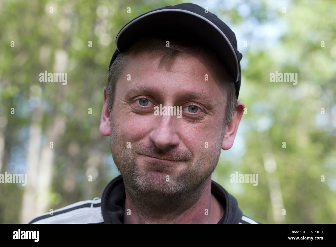 Closeup head shot of a happy man wearing cap, jogging in a park Stock ...